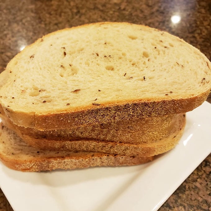 This isn't just rye bread; it's the sturdy foundation upon which deli dreams are built—seeded, crusty, and perfect.