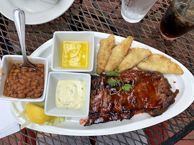 BBQ artistry on a plate – glistening ribs and golden perch create the ultimate surf and turf Indiana-style.