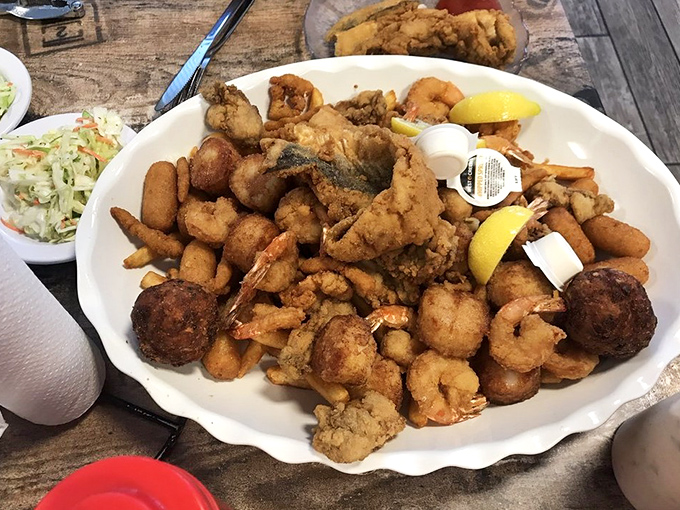 Seafood nirvana on a plate. This fried sampler isn't trying to win beauty contests – it's too busy making your taste buds dance.
