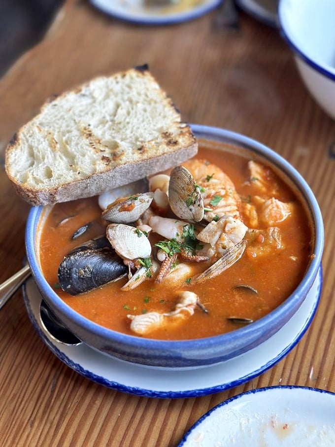 This isn't just soup—it's an underwater party where shellfish, fish, and broth have gathered to throw the best bash in your bowl.