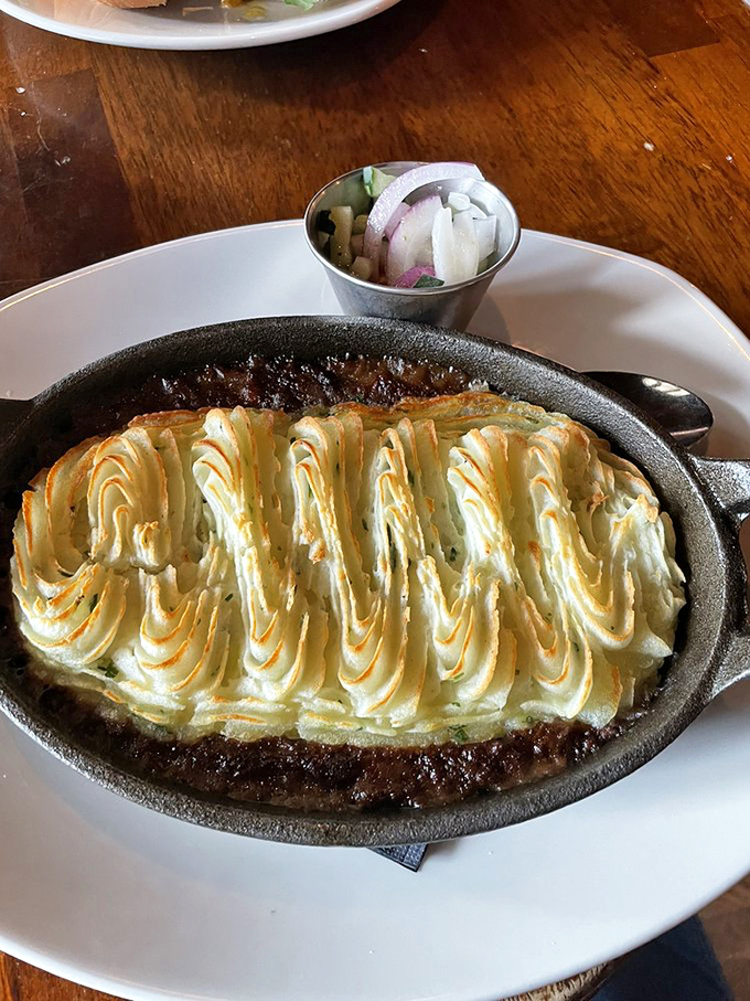 Behold the star attraction – shepherd's pie with its golden potato peaks hiding a savory treasure of meat and vegetables below.