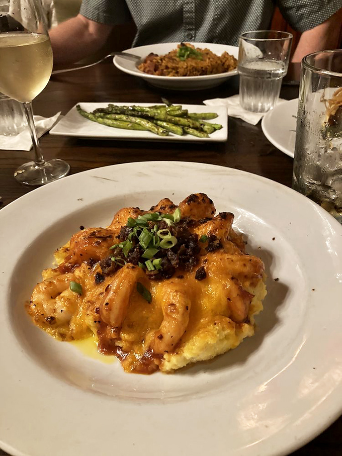 Behold the holy grail of Lowcountry cuisine! Plump shrimp nestled atop creamy grits with bacon and green onions—comfort food that's dressed for the opera.