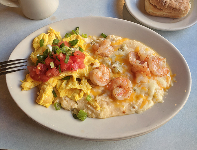 Behold the legendary shrimp and grits—creamy, cheesy goodness topped with plump shrimp and scrambled eggs. This plate has launched a thousand return visits.