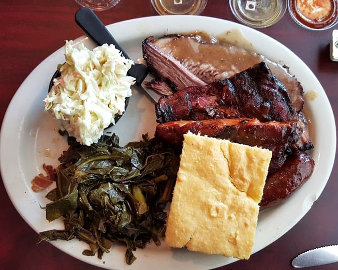 Barbecue nirvana on a plate: tender brisket with that perfect smoke ring, collard greens, and cornbread that would make your grandmother jealous.