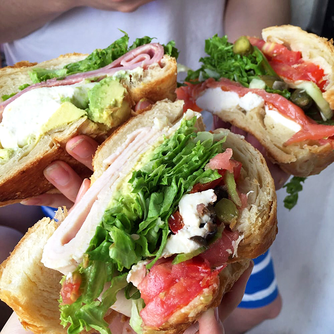 Croissant sandwiches that would make a Parisian weep with joy. The perfect marriage of buttery pastry and fresh fillings—a honeymoon in every bite.