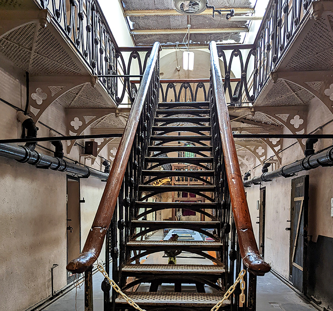 These iron stairs weren't designed for comfort—each step a reminder that the journey upward was just leading to more confinement.