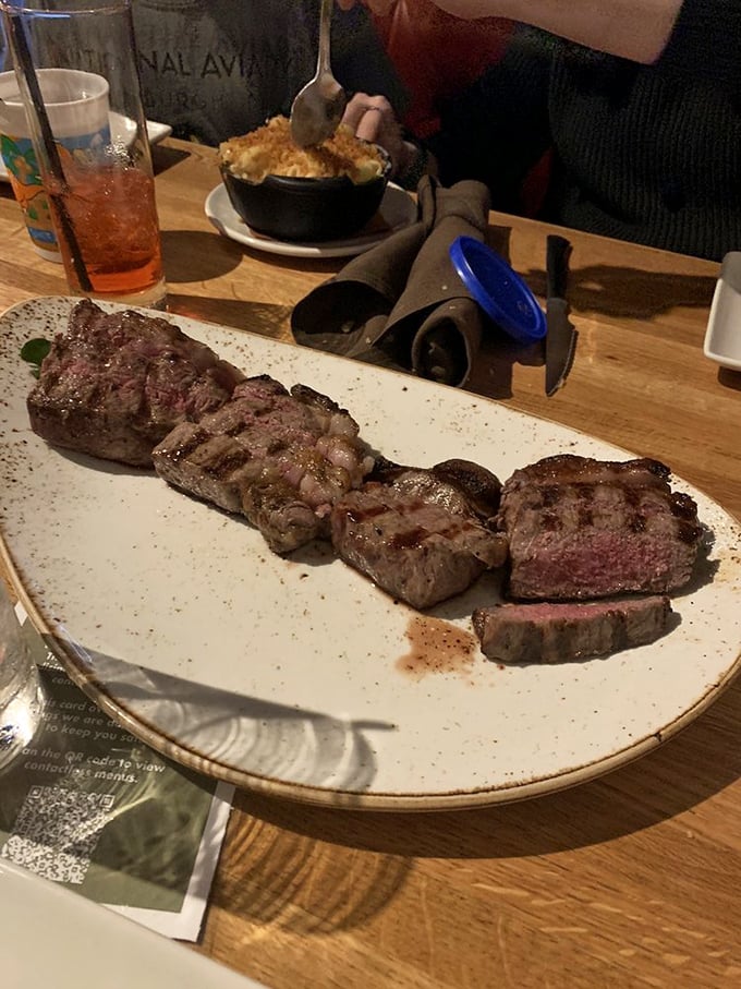 Behold the star of the show—perfectly seared steak sliced to showcase that rosy interior. This isn't dinner; it's performance art.