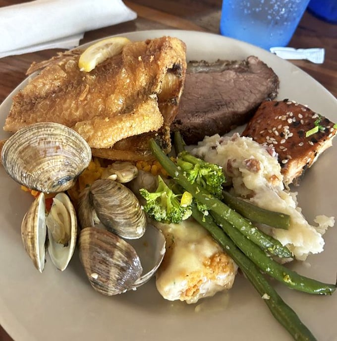 A plate that tells the whole story – surf meets turf in a delicious summit where clams, fish, and prime rib negotiate peaceful coexistence.