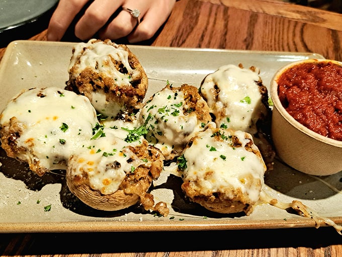 These stuffed mushrooms aren't just appetizers—they're little silver-dollar stages where cheese performs its most magnificent melting act.