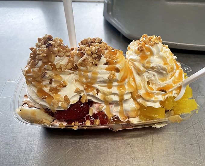 Behold the banana split in its natural habitat—a symphony of textures where warm caramel cascades over cold cream like Florida sunshine after a summer storm.