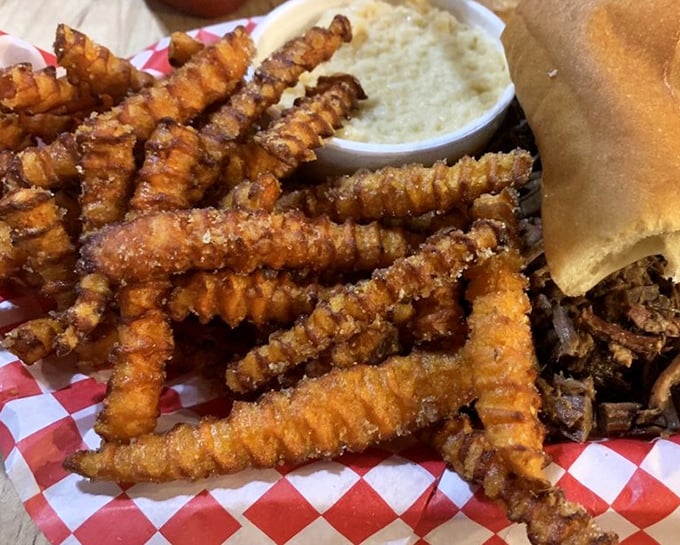 These aren't your average sweet potato fries—they're crispy, ridged flavor vehicles dusted with cinnamon and sugar. The kind that make conversation stop mid-sentence.