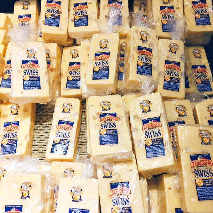 Swiss cheese heaven exists, and it's stacked neatly in this display case. Those perfect holes aren't accidents—they're little windows into craftsmanship.