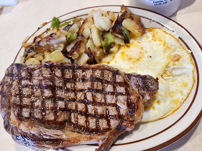 This isn't just any steak and eggs—it's the reason alarm clocks were invented. Perfect grill marks tell you everything you need to know.