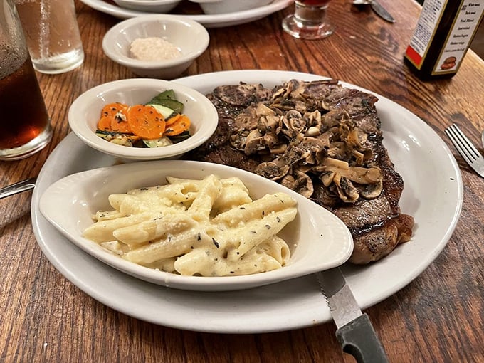 Behold the steak whisperer's masterpiece: perfectly seared beef topped with mushrooms alongside pasta and veggies. This is what food dreams are made of.