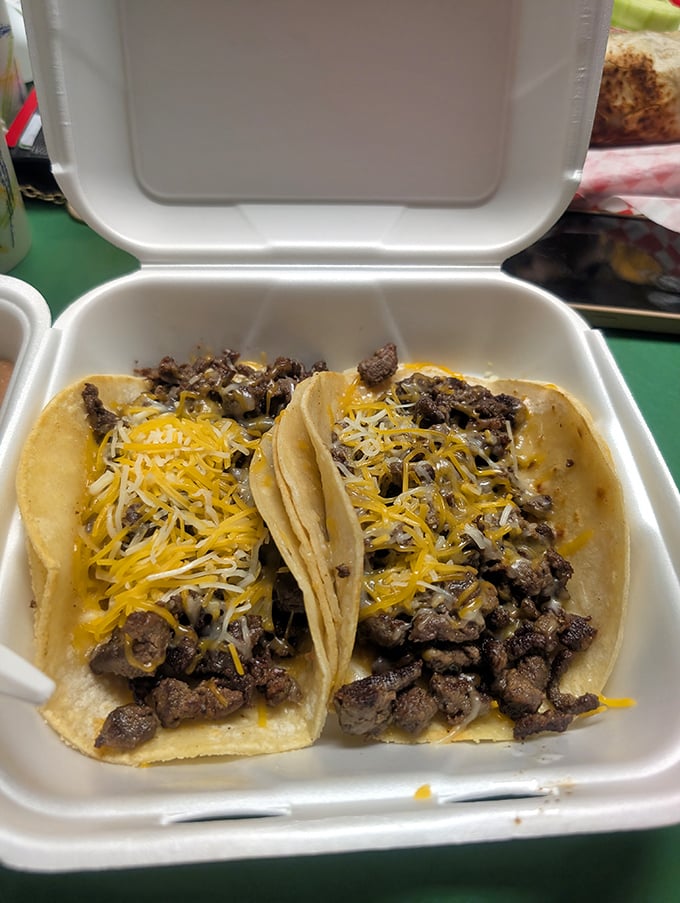 These aren't just tacos—they're tiny flavor festivals wrapped in corn tortillas, topped with melty cheese that stretches like your waistband will.