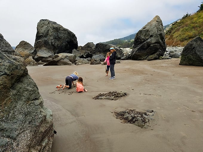Family treasure hunting among Stinson's rocky coves. One person's "just a rock" is another's priceless souvenir.