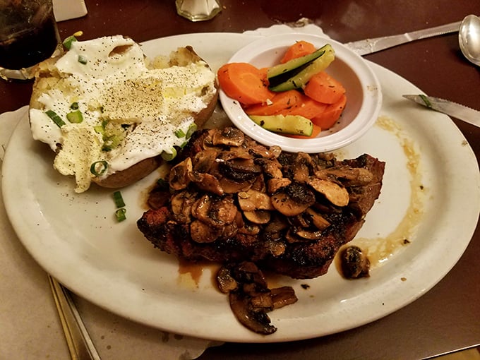 This tri-tip steak topped with sautéed mushrooms isn't just dinner – it's what food dreams are made of. The loaded potato stands guard.