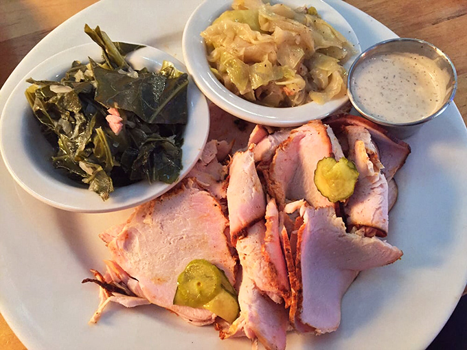 Smoked turkey that's had a proper Southern upbringing, flanked by collards and cabbage that didn't just fall off the turnip truck yesterday.