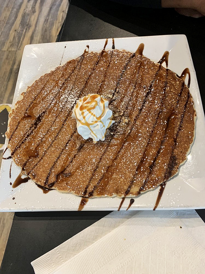 Dessert masquerading as breakfast? This pancake, drizzled with caramel and topped with whipped cream, makes a compelling argument for starting your day with something sweet.