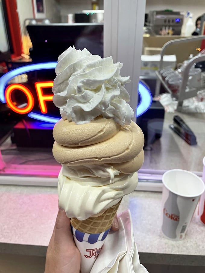 Behold the architectural marvel that is Mike's soft serve—a towering swirl of vanilla and pumpkin that defies both gravity and sadness.