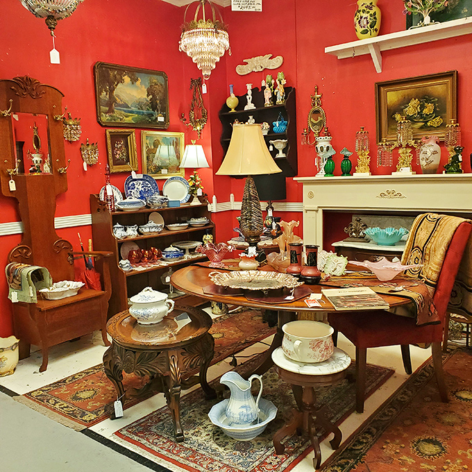 A crimson-walled booth creates the perfect stage for antique treasures. That fireplace mantel isn't just furniture—it's an invitation to reimagine your living room.