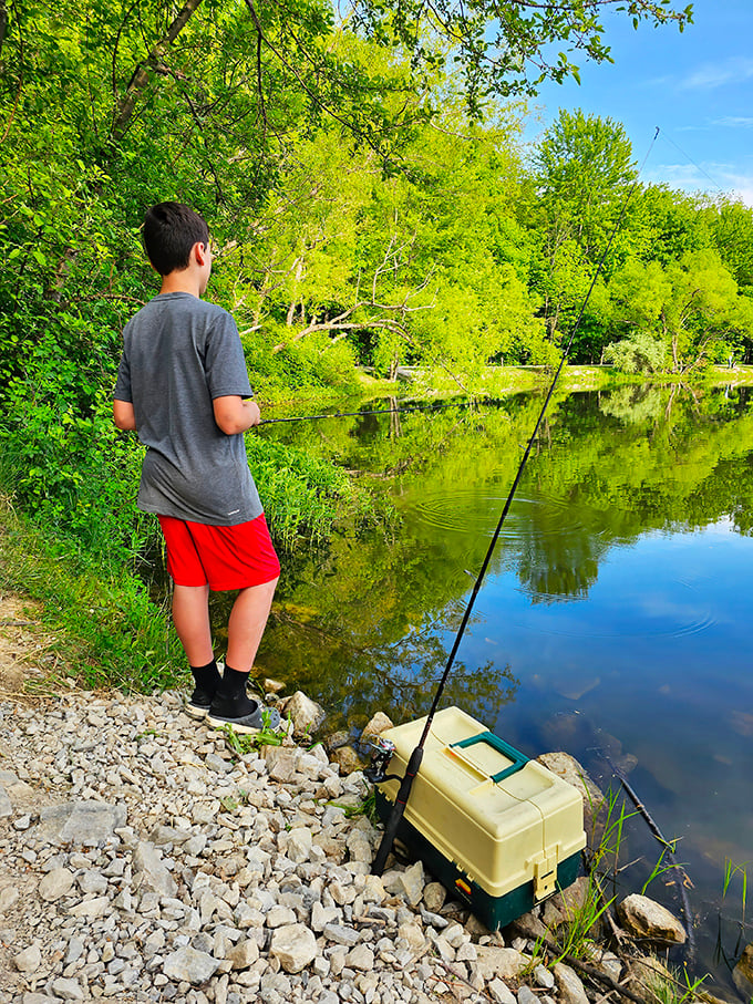 Patience pays off at Hidden Lake. This young angler demonstrates the timeless truth that fishing isn't about catching—it's about the perfect excuse to stand quietly in nature.