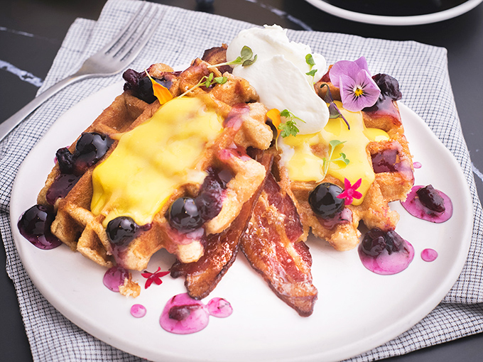 These aren't just waffles; they're edible art canvases where blueberries, lemon curd, and edible flowers come together in a breakfast symphony worthy of a standing ovation.