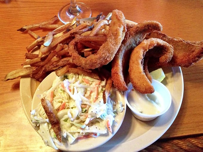 Crispy golden onion rings and those famously "greasy" fries frame the star attraction. The coleslaw provides a cool, creamy counterpoint to all that delicious crunch. 