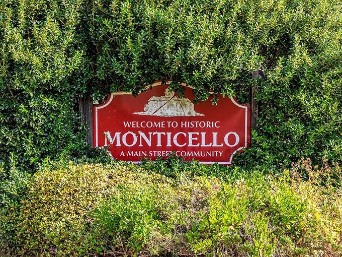 "Welcome to Historic Monticello"—where the sign is nestled in greenery as if to say, "Slow down, you're not in Disney anymore."