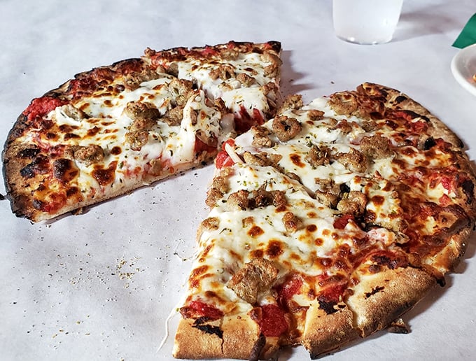 This isn't just pizza—it's a wood-fired masterpiece with perfectly charred crust and bubbling cheese that would make an Italian grandmother weep with joy.