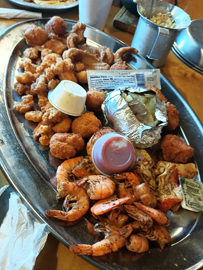 This isn't just a seafood platter—it's a celebration on metal. Crispy catfish nuggets, seasoned shrimp, and a loaded potato create the holy trinity of satisfaction.