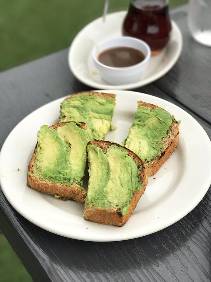 Three perfect slices of avocado toast that prove sometimes the simplest pleasures are the most satisfying – no fancy garnishes needed.