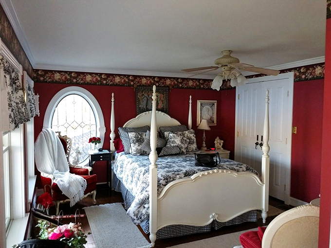 Sleep like royalty in this four-poster bed surrounded by rich crimson walls. The only thing missing is a lady's maid to bring your morning chocolate.