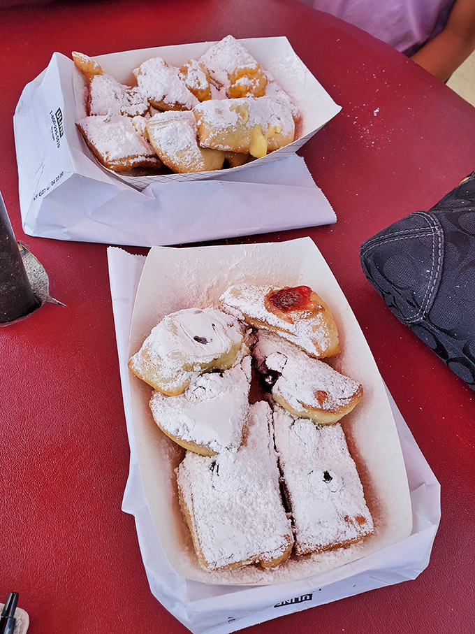 Powdered sugar paradise! These beignets aren't just desserts—they're pillowy clouds of fried perfection that'll have you planning your next visit before finishing.