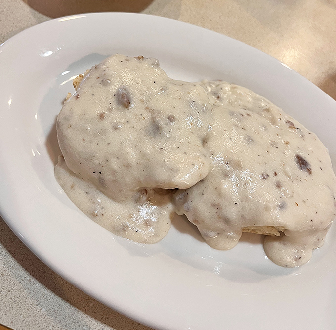 Behold the star attraction: biscuits smothered in peppery sausage gravy. This plate doesn't just speak to your soul—it sings a full opera.