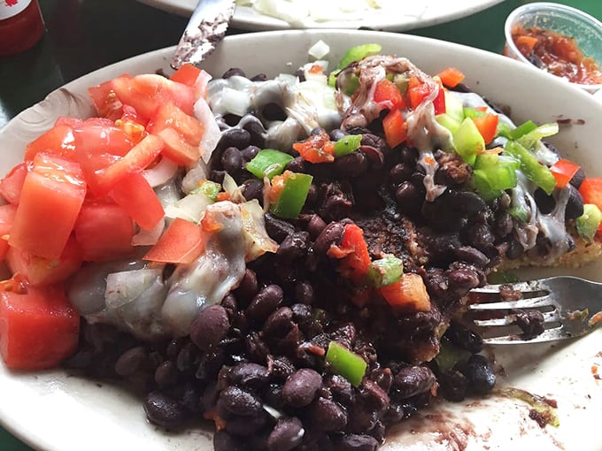 The legendary black bean corn cake in its full glory—where beans, fresh veggies, and melted cheese create a texture symphony that haunts your dreams.