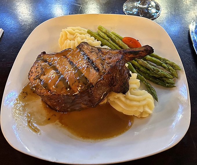 This bone-in pork chop with mashed potatoes and asparagus isn't just dinner—it's a reprieve from ordinary meals that governor would approve.