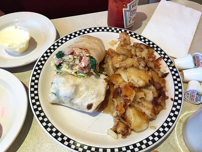 This isn't just breakfast – it's a morning masterpiece. That omelet practically demands its own zip code, while those home fries deserve a standing ovation.