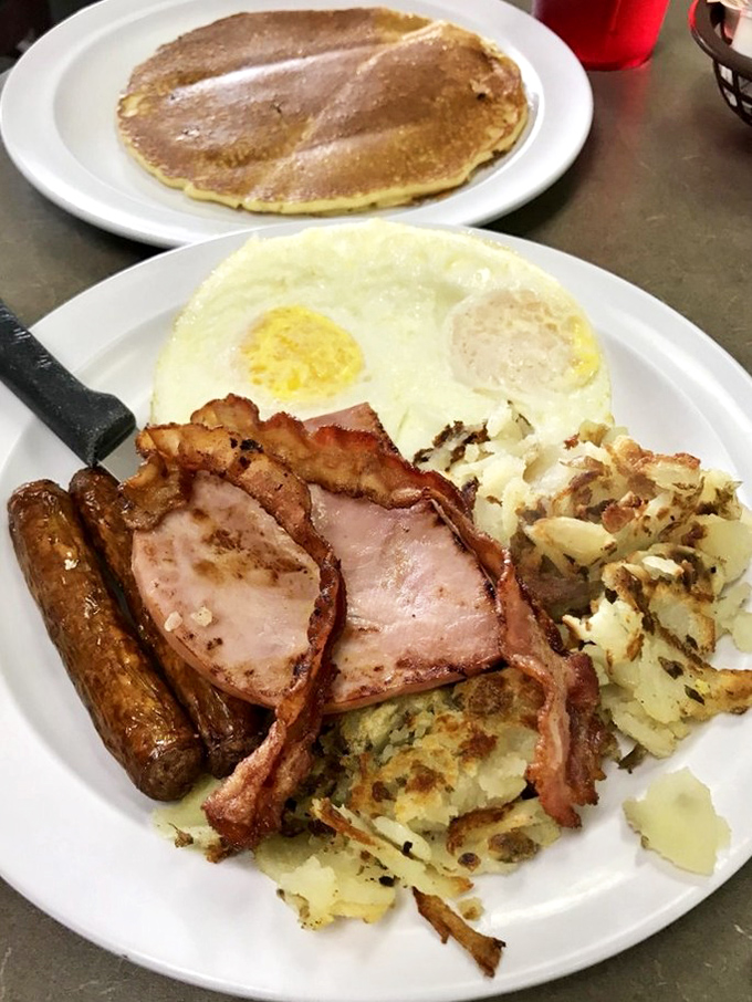 Biscuits drowning in creamy gravy with a golden hash brown on the side—proof that sometimes the most delicious things in life aren't the most photogenic.