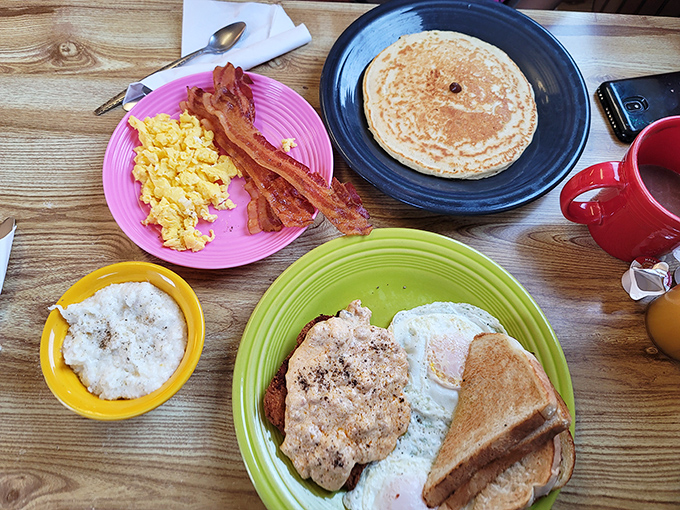 Behold the breakfast that makes chain restaurants weep with envy – generous portions on colorful, cheerful plates.