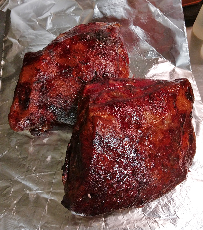 Behold, barbecue nirvana: brisket with a bark so perfect it deserves its own trophy. The deep mahogany crust holds secrets only smoke and time can reveal.