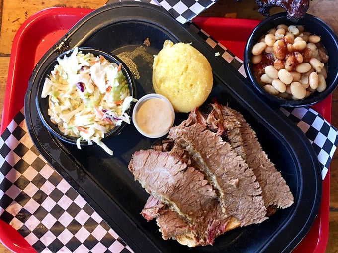 Brisket doesn't lie—and this plate is telling a delicious truth with perfectly smoked meat, creamy slaw, golden cornbread, and beans that didn't come from any can.