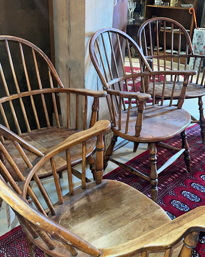 These Windsor chairs have witnessed more family dinners than Thanksgiving at Grandma's. The wood has aged more gracefully than most Hollywood stars.