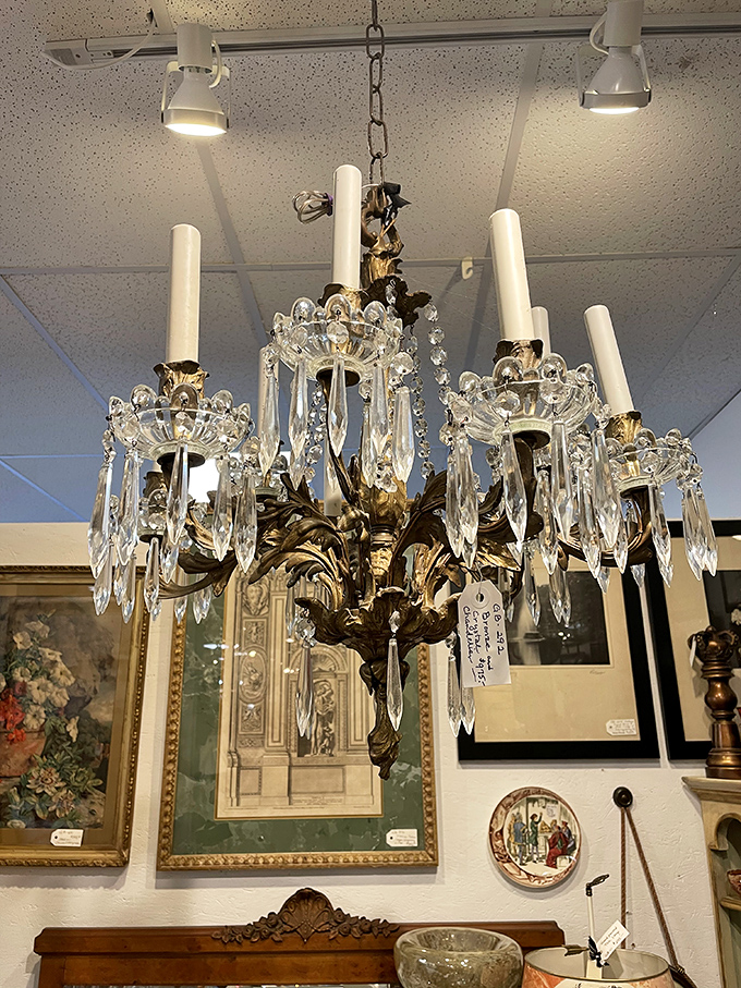 Crystal chandeliers dangle like elegant jewelry from the ceiling, each one whispering stories of grand ballrooms and elegant dinner parties from bygone eras.