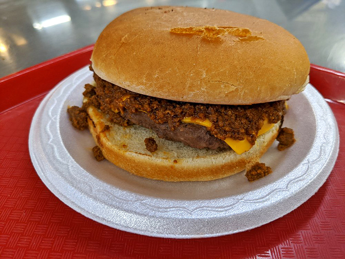 Behold the famous chili cheeseburger in all its messy glory—where the meat-to-bun ratio defies physics and napkins are not optional but mandatory.