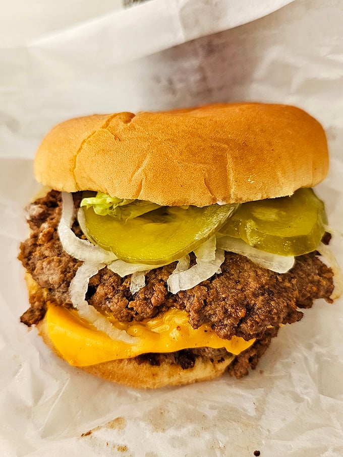 Behold the cheeseburger in its natural habitat—unpretentious, honest, and dressed with pickles that mean business. This isn't Instagram food; this is soul food.