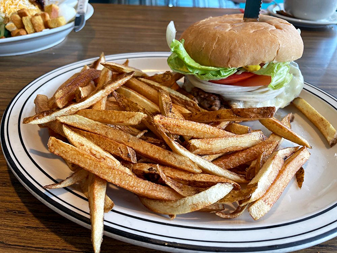 The star of the show: a perfectly proportioned cheeseburger with hand-cut fries that would make Julia Child weep with joy. Simple food done right.