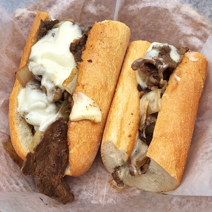 Behold the star of the show – thinly sliced ribeye embraced by melted cheese on that perfect roll. Poetry in sandwich form.