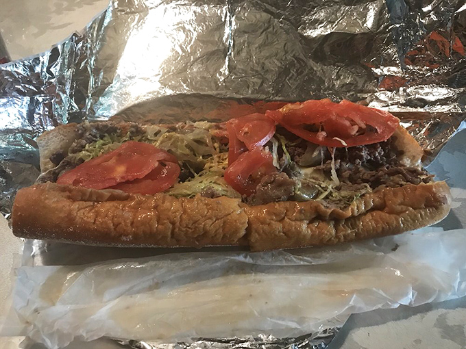 Behold the marriage of beef and bread that makes Philadelphians proud. This isn't just a sandwich—it's edible architecture with tomatoes as the crown jewels.