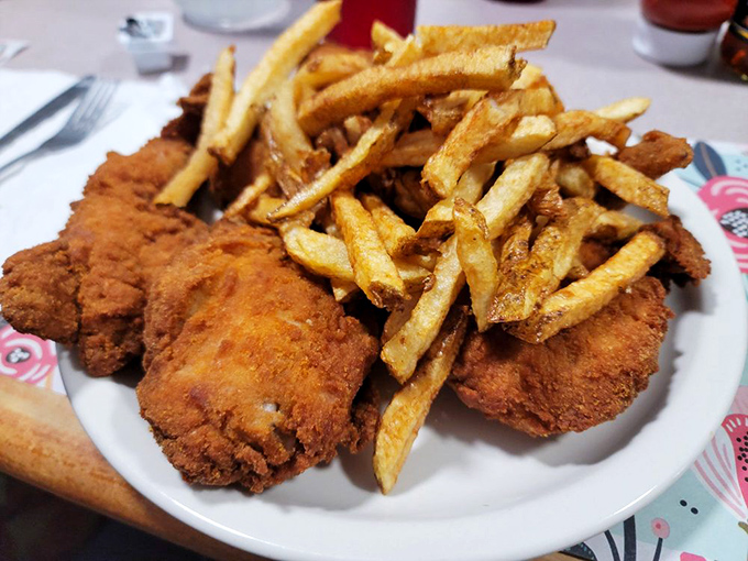 Golden-brown perfection meets hand-cut fries in a plate that doesn't need Instagram filters—just your immediate, undivided attention.